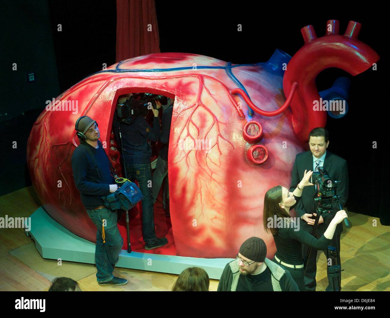 Journalists surround an accessible model of a human heart at the ...