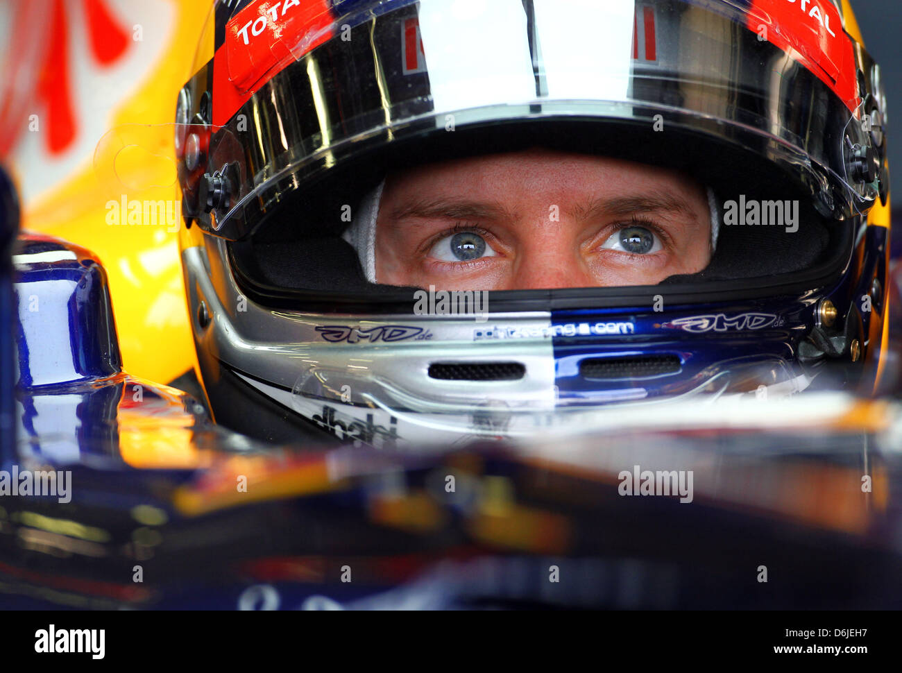 German Formula One driver Sebastian Vettel of Red Bull sits in his car ...