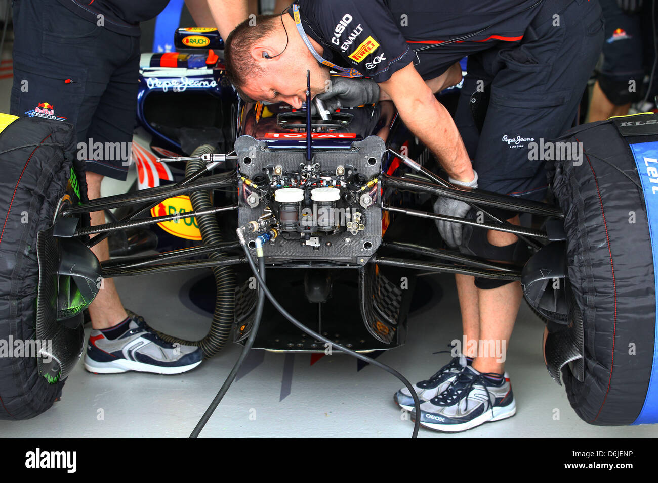 A mechanic of Red Bull works on the car of German Formula One driver ...