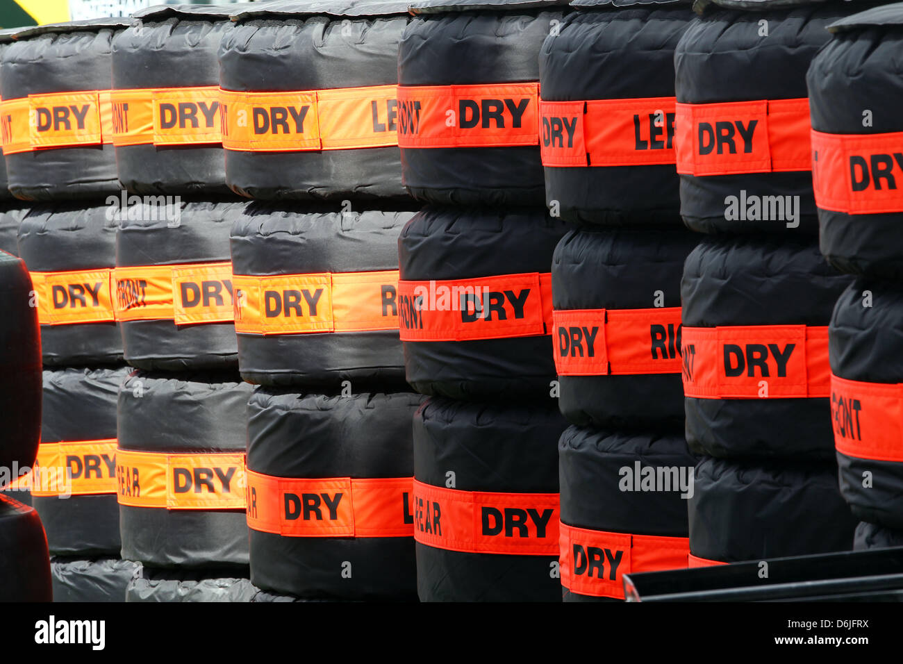 Racing tires for dry weather are piled-up in the paddock for the third ...