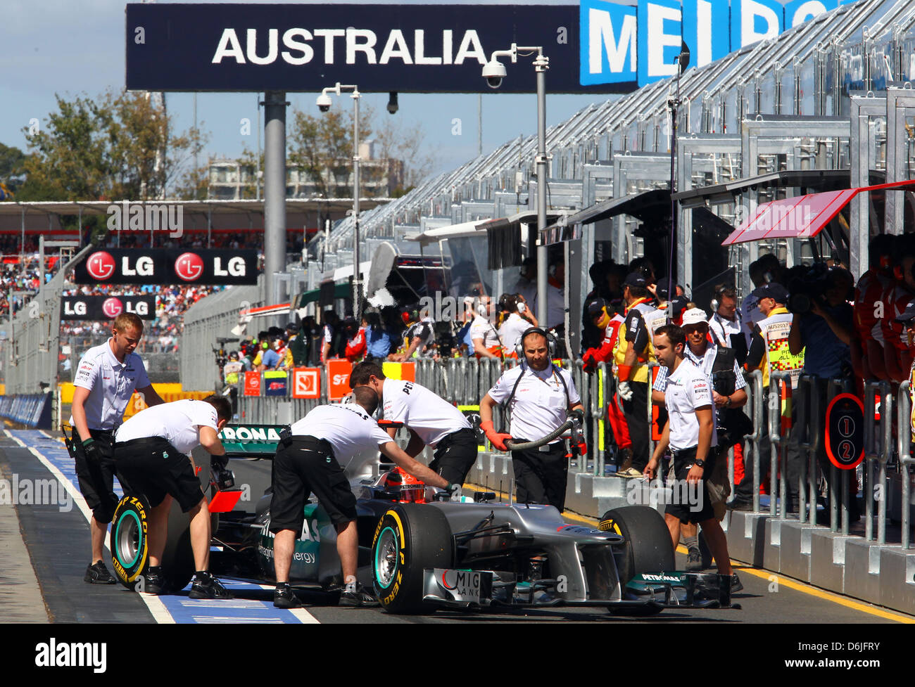 Mechanics push the racing car of German Formula One driver Michael ...