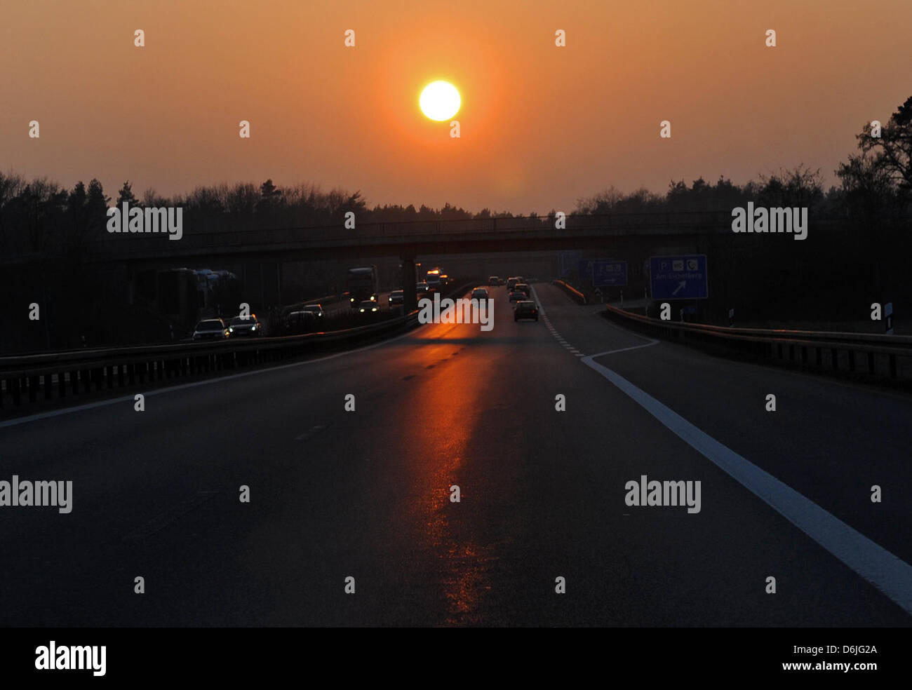 The setting sun colours the sky above the Autobahn A4 near Dresden ...
