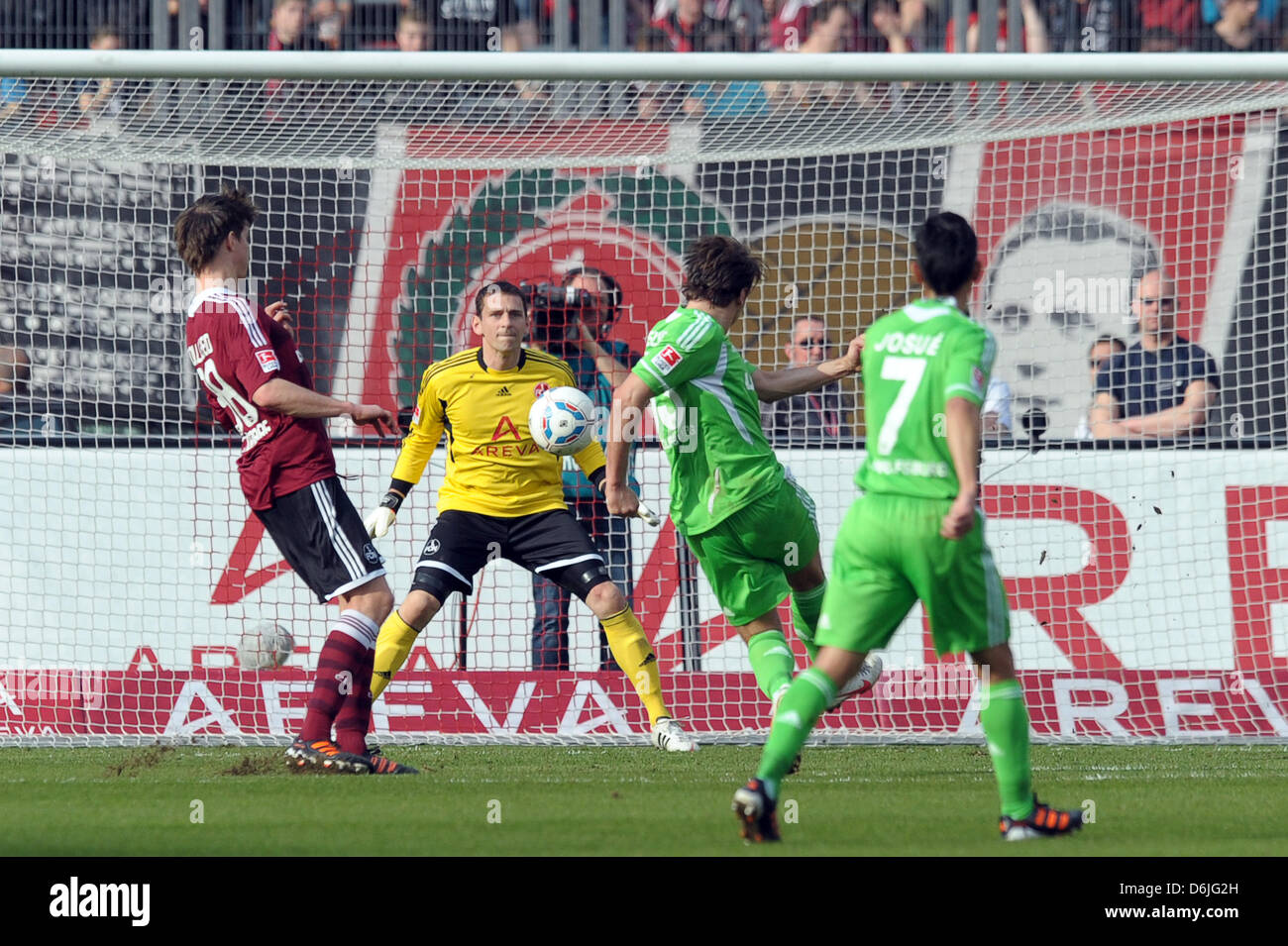Nuremberg's goalkeeper Raphael Schaefer (2-L) cannot save the shot by ...