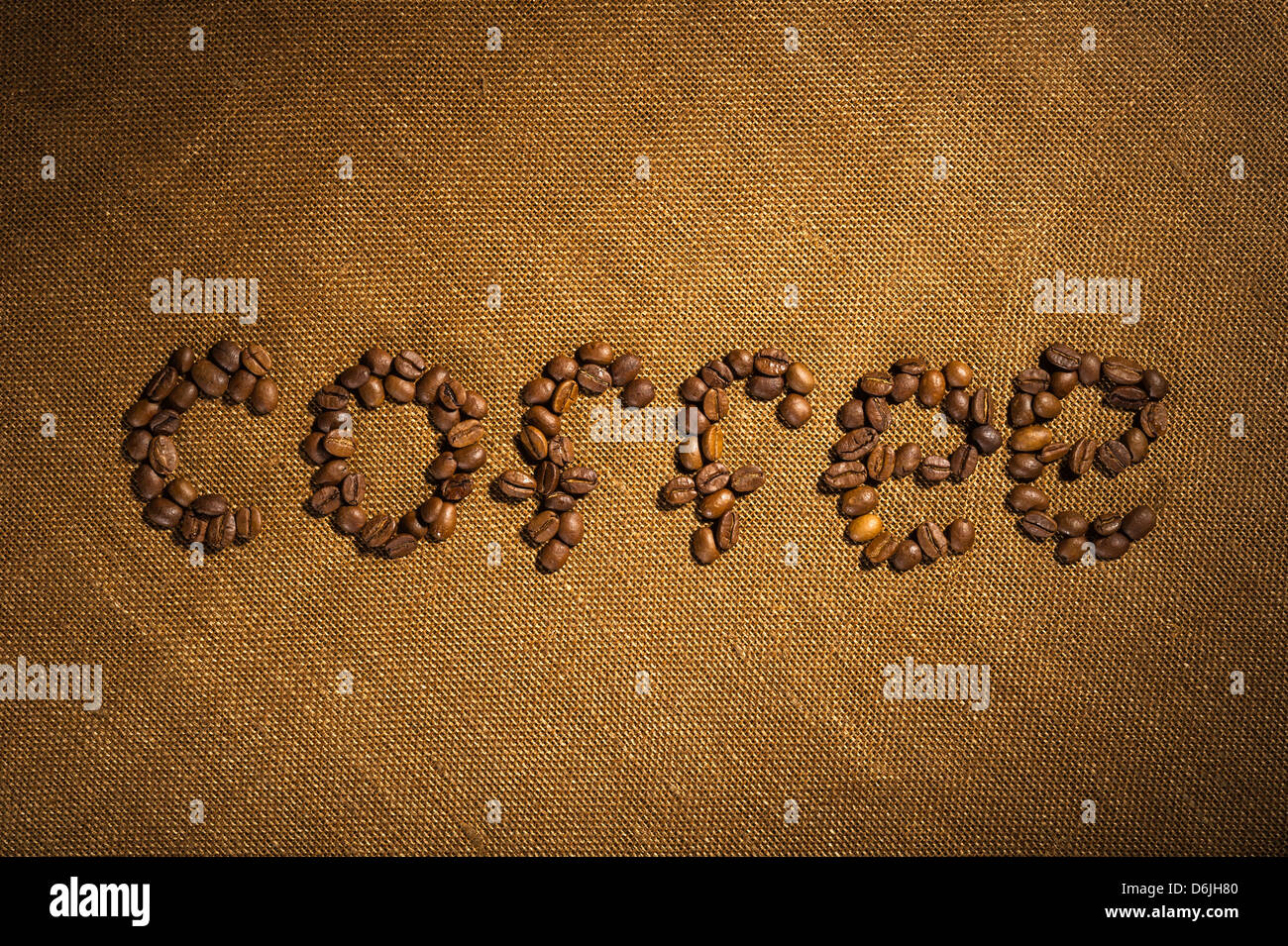 The word coffee made from coffee beans on fabric texture Stock Photo ...