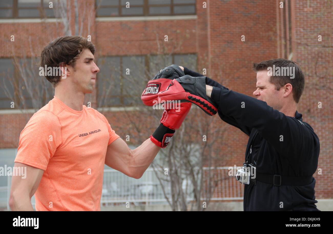 US American swimmer Michael Phelps (L) boxes with his trainer Kennan ...