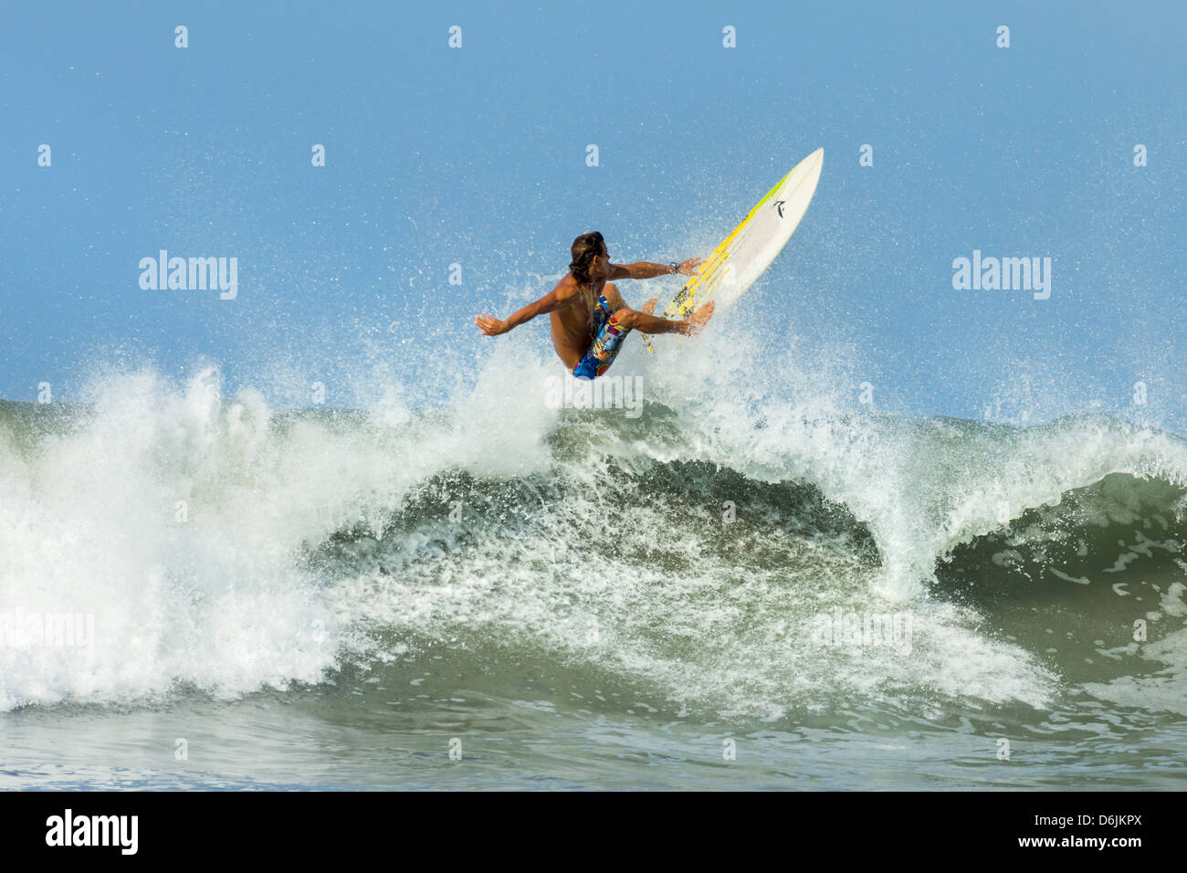 Surfer on shortboard riding wave at popular Playa Guiones surf beach ...