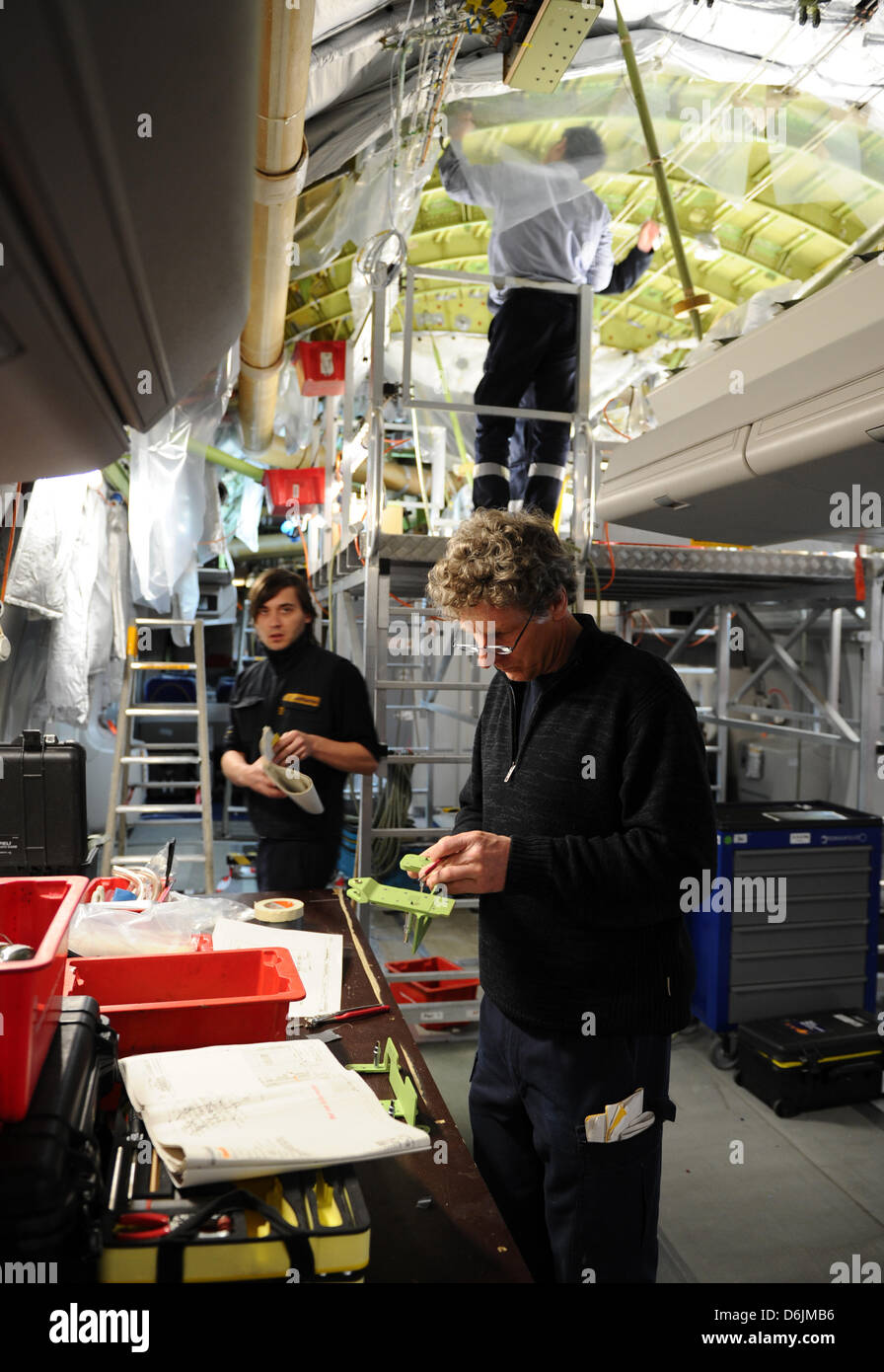 Technicians work on the interior of a Boeing 747-400 at a Jumbo ...