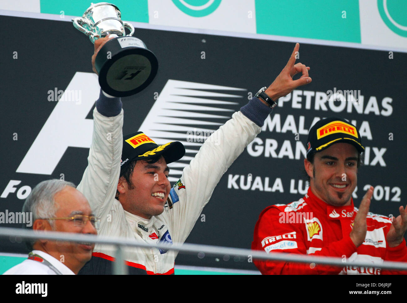 Spanish Formula One driver Fernando Alonso (R) of Ferrari celebrates on ...