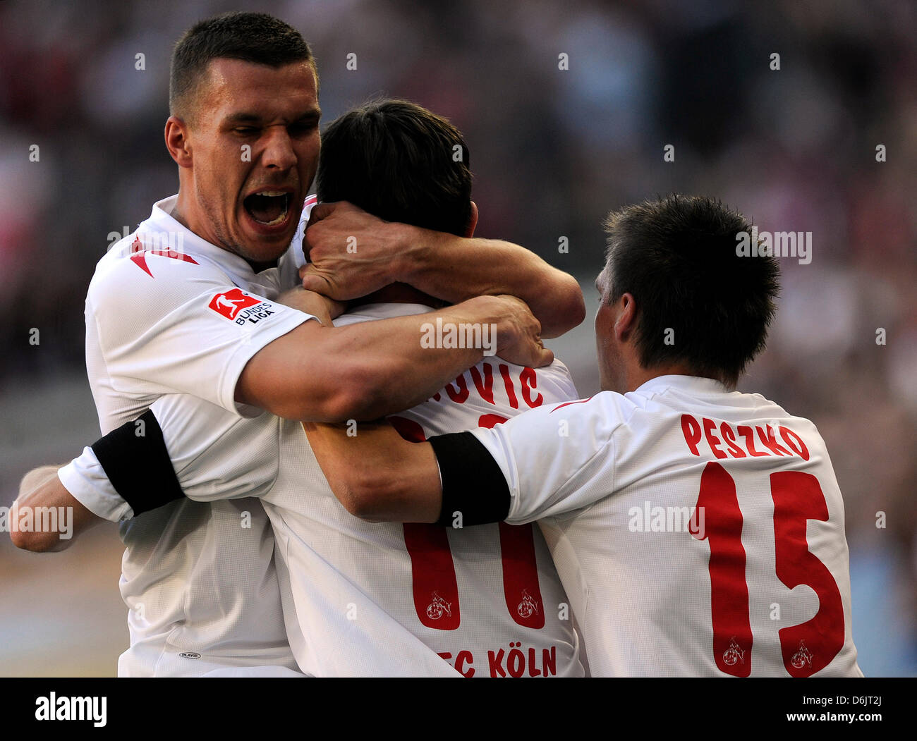 Cologne's Lukas Podolski (L-R), scorer Milivoje Novakovic and Slawomir ...