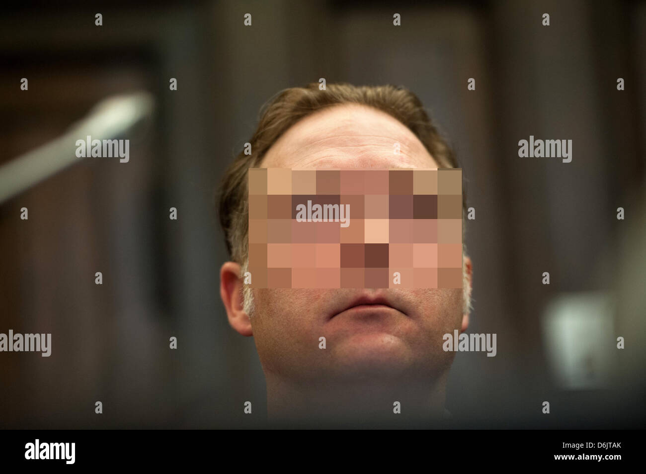 The defendant sits in the court room of the Regional Court in Hamburg ...