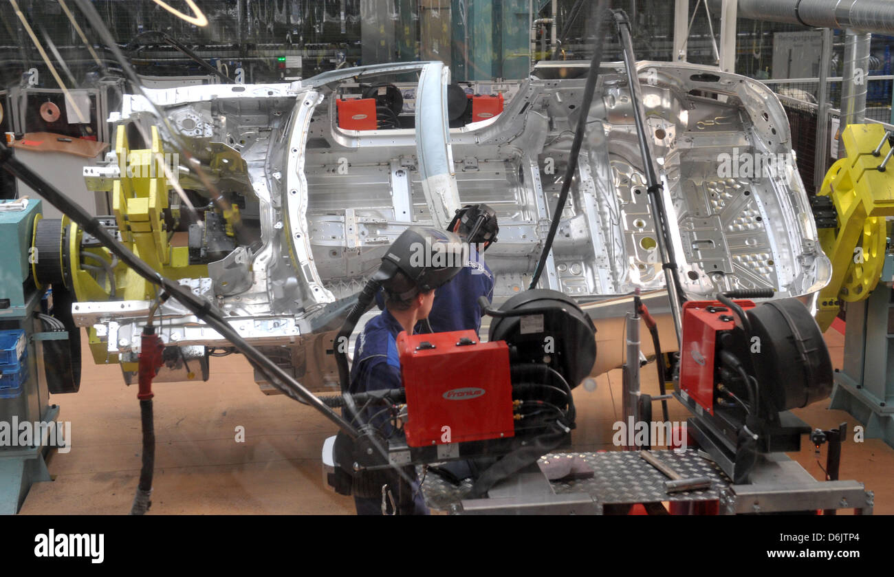 A mechanic works on the body of the new Mercedes-Benz SL sports car at ...