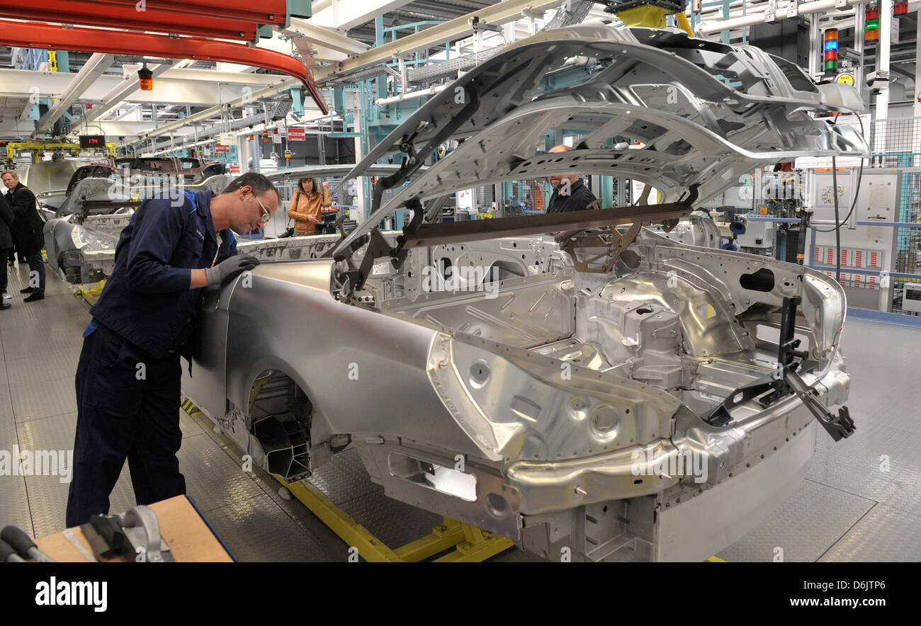 A mechanic works on the body of the new Mercedes-Benz SL sports car at ...
