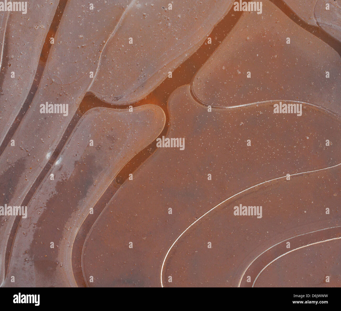 An ice covered muddy puddle Stock Photo - Alamy