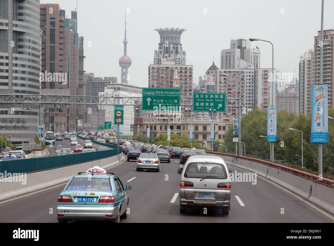 Cars drive along a street in Shanghai, China, 19 April 2013. The ...