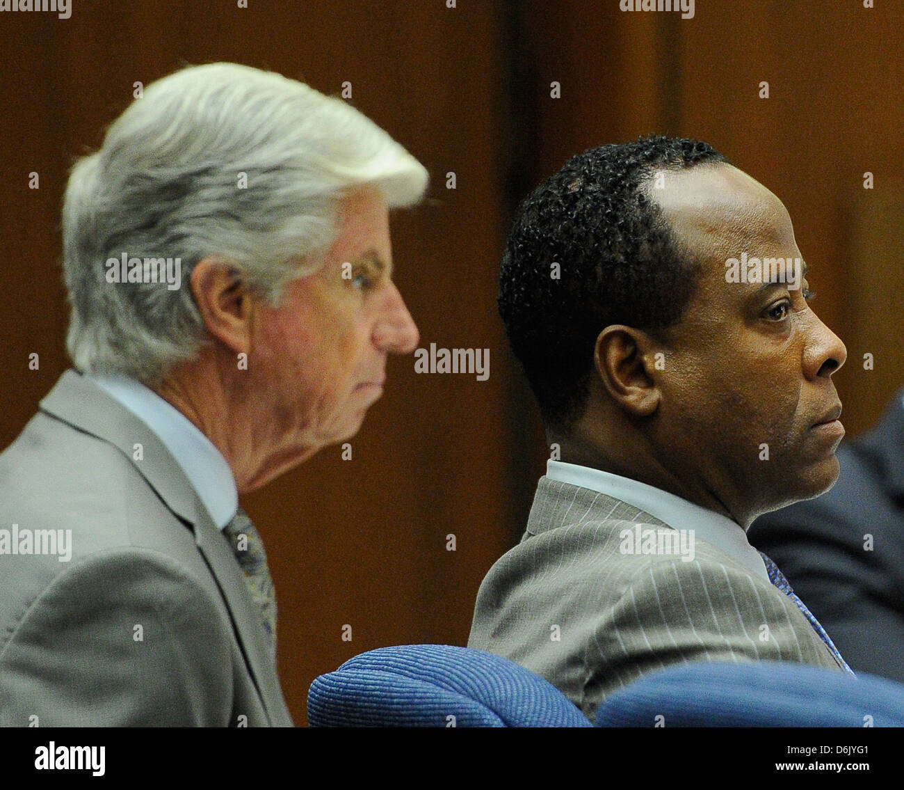 Defense Attorney J. Michael Flanagan and Dr. Conrad Murray look on ...