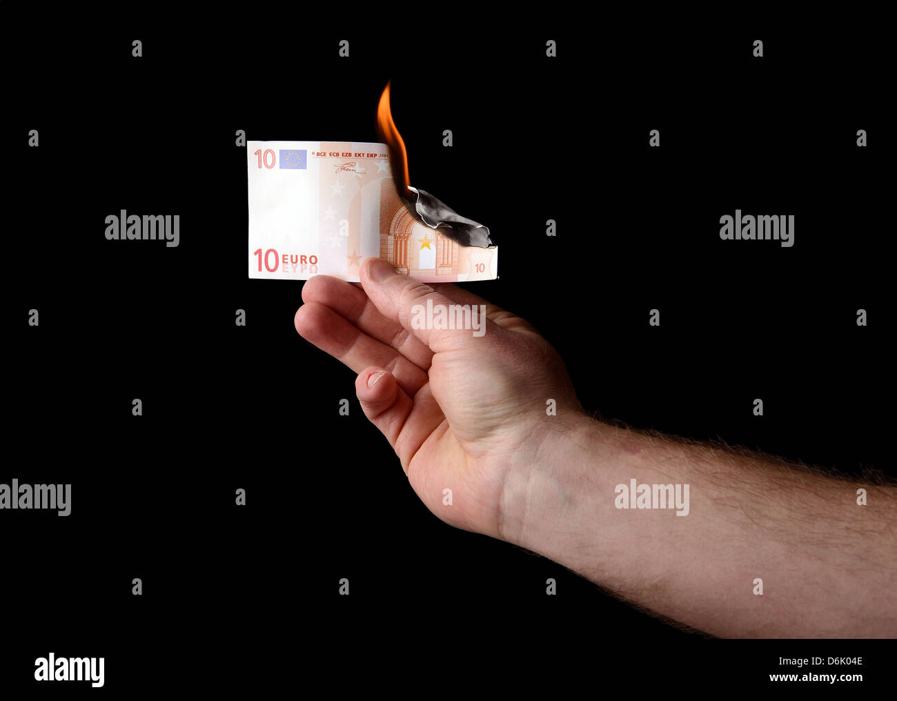 euro note burning on a isolated black background Stock Photo - Alamy