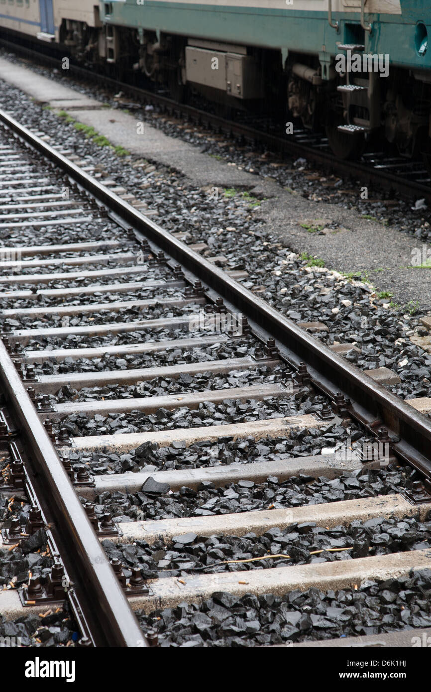 Railway Track and Platform and Train in the Rain Stock Photo - Alamy