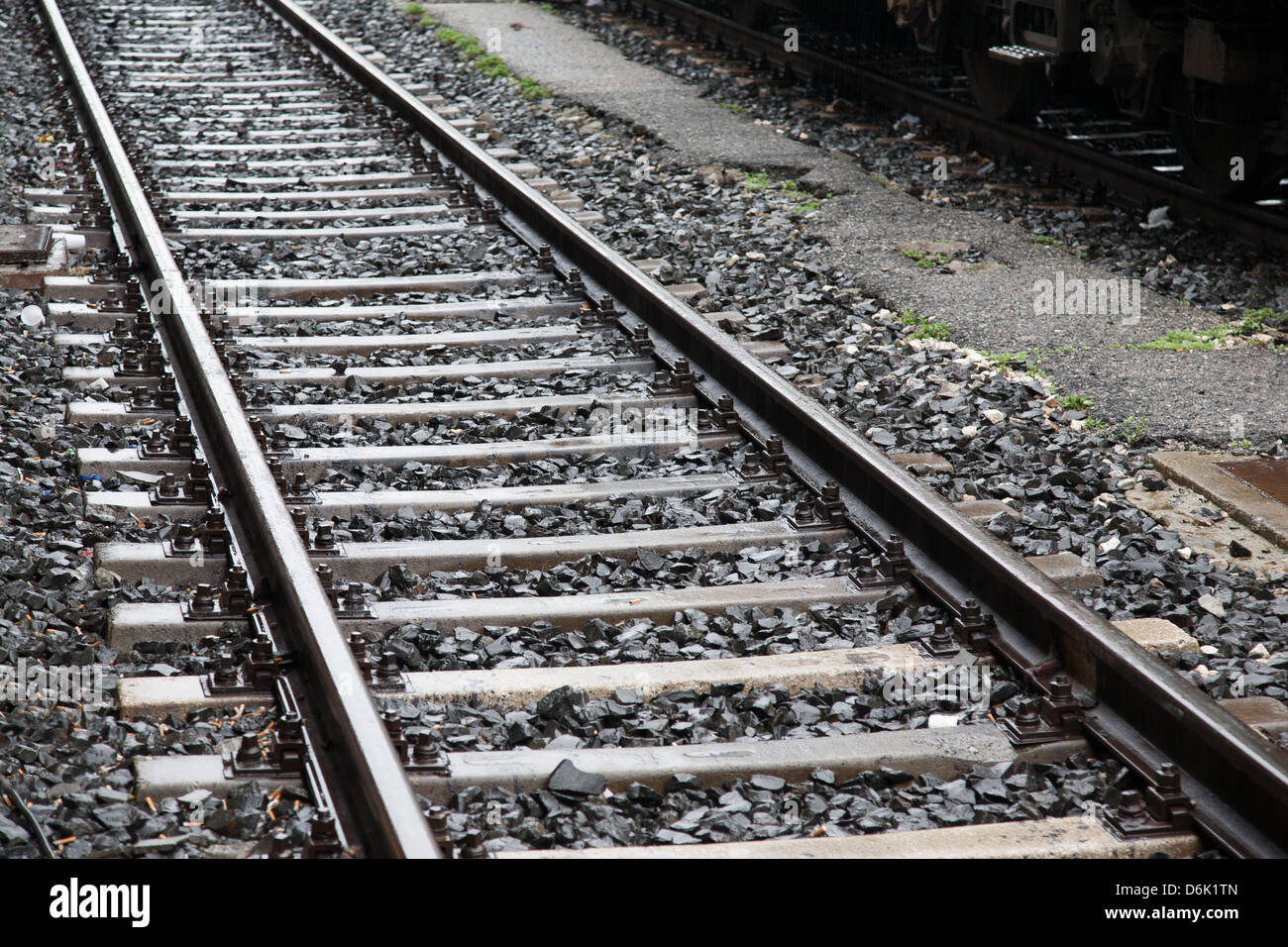Railway Track and Platform and Train in the Rain Stock Photo - Alamy