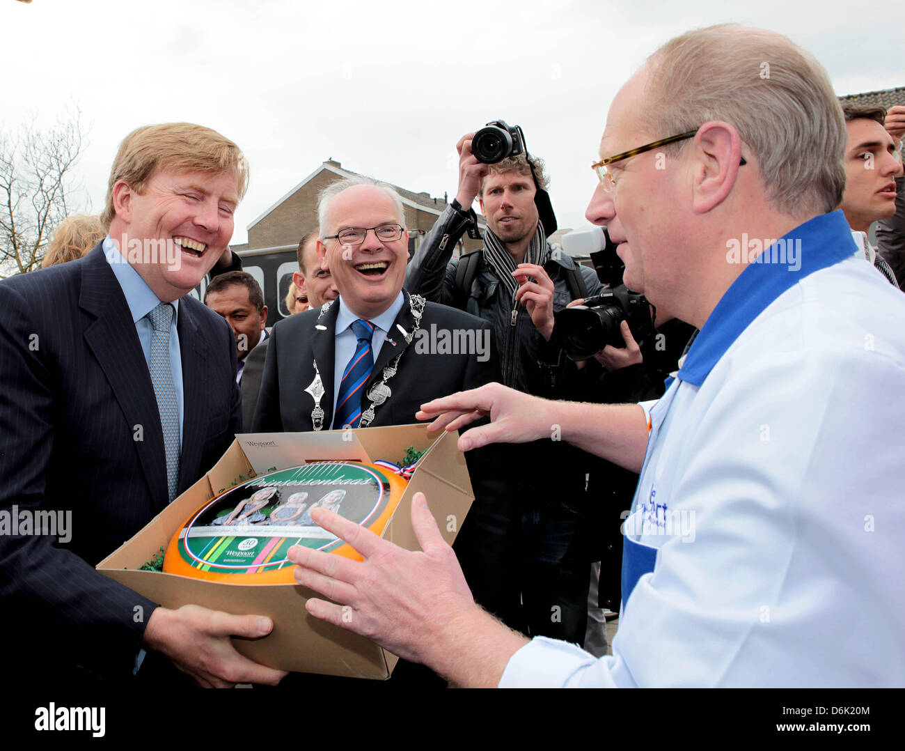 Dutch Prince Willem-Alexander (L) receives a cheese as a gift during ...
