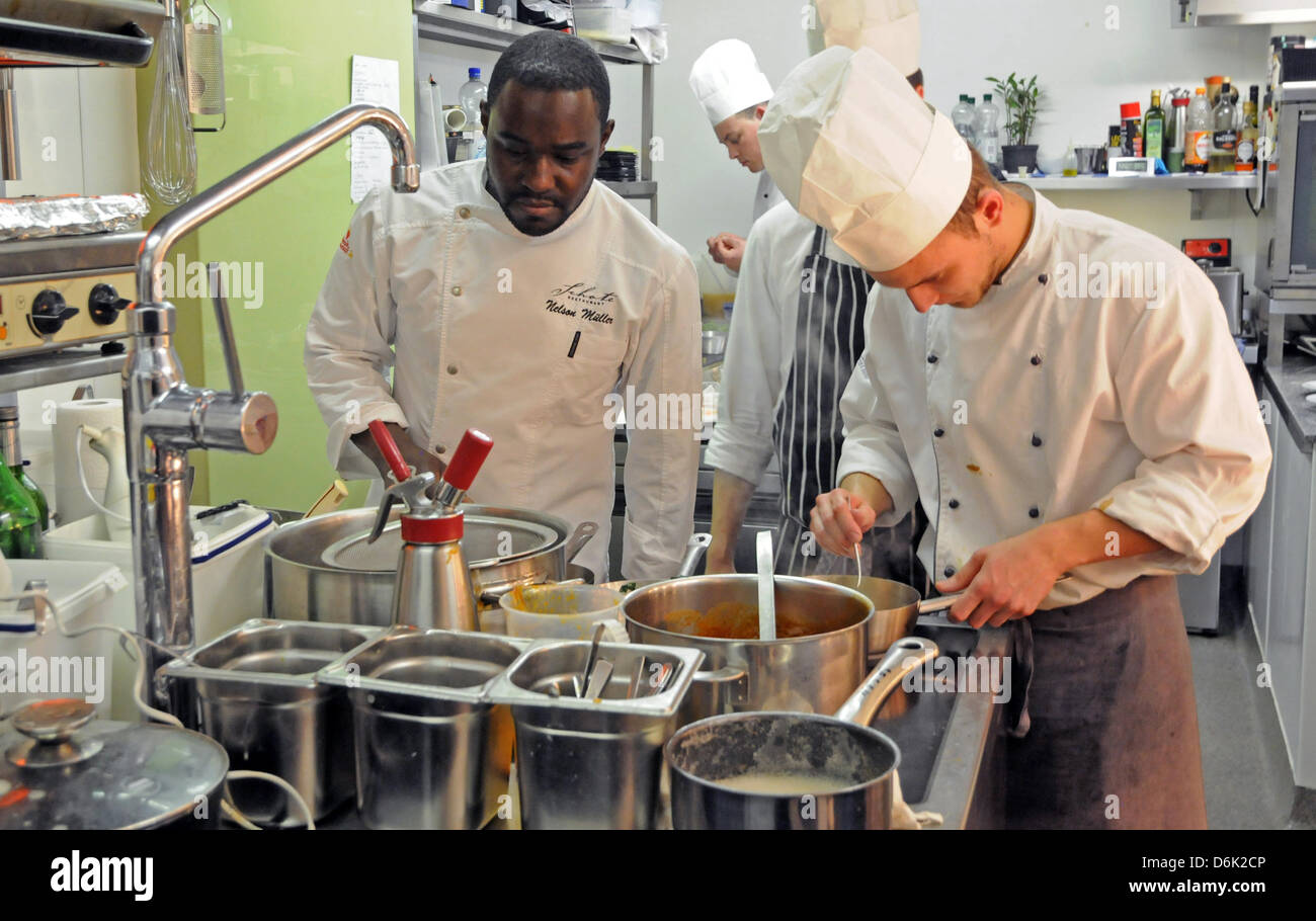 Starred chef Nelson Mueller (L) is pictured in the kitchen of his ...