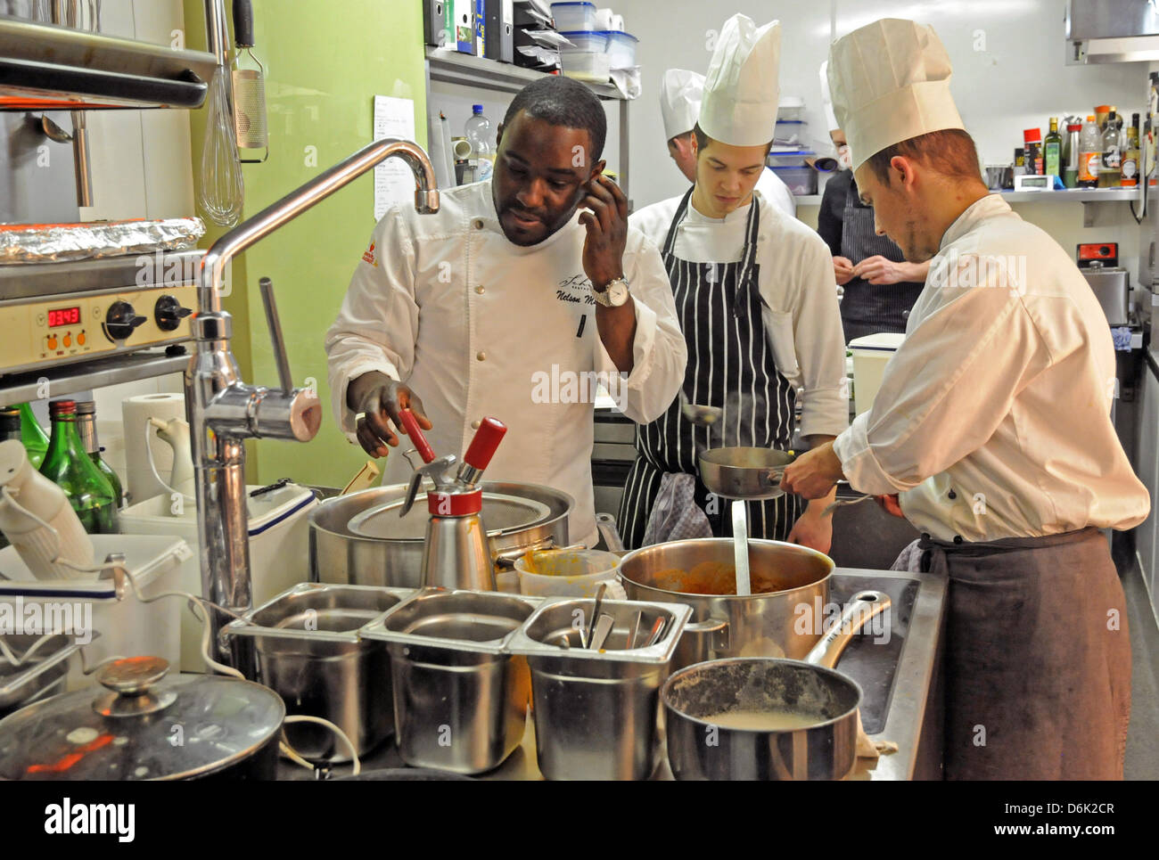 Starred chef Nelson Mueller (L) is pictured in the kitchen of his ...