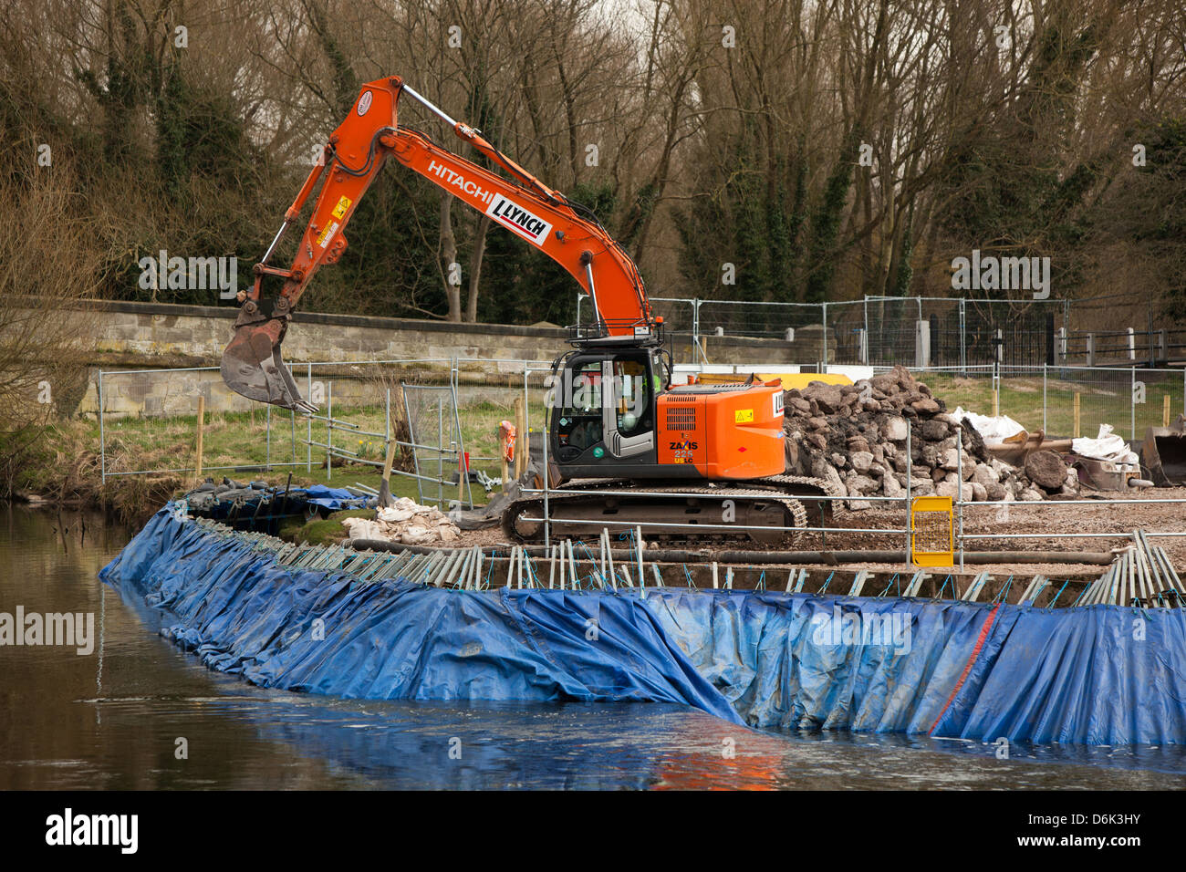 An Hitachi mechanical digger working on constructing a fish pass. On ...
