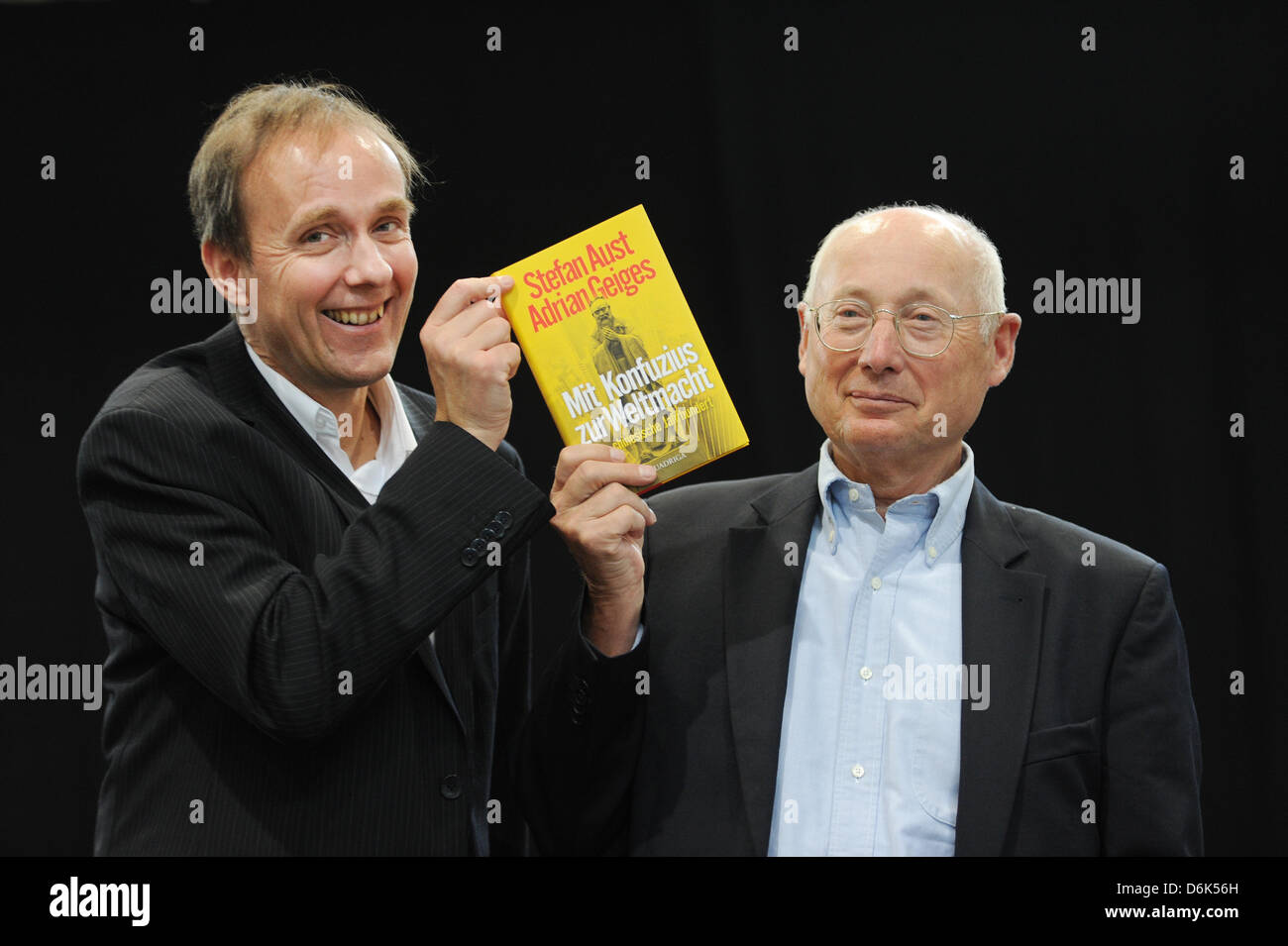 Stefan Aust (R) and Adrian Geiges pose with their book 'With Confucius ...