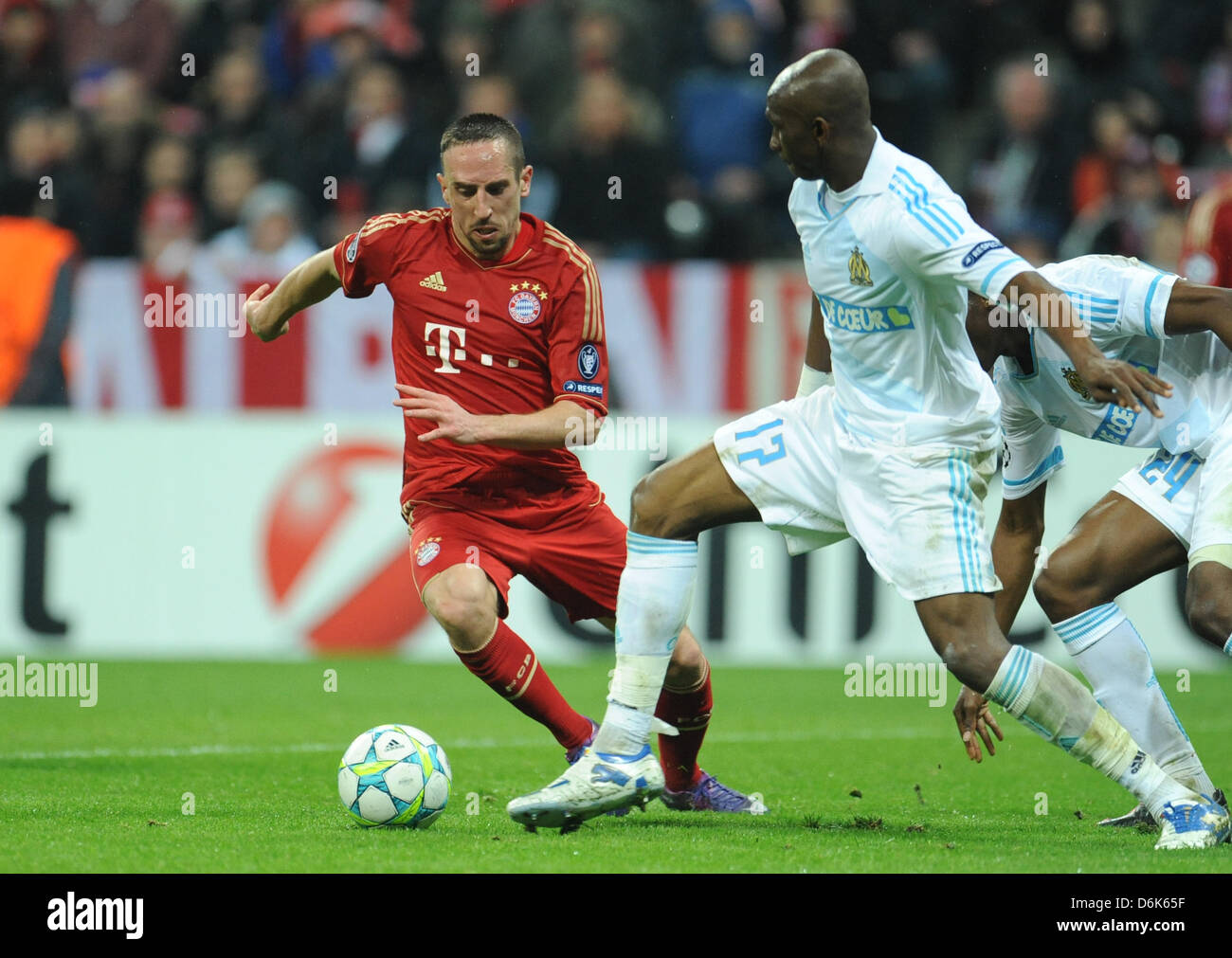 Munich's Franck Ribery (L) and Stephane Mbia of Olympique Marseille vie ...
