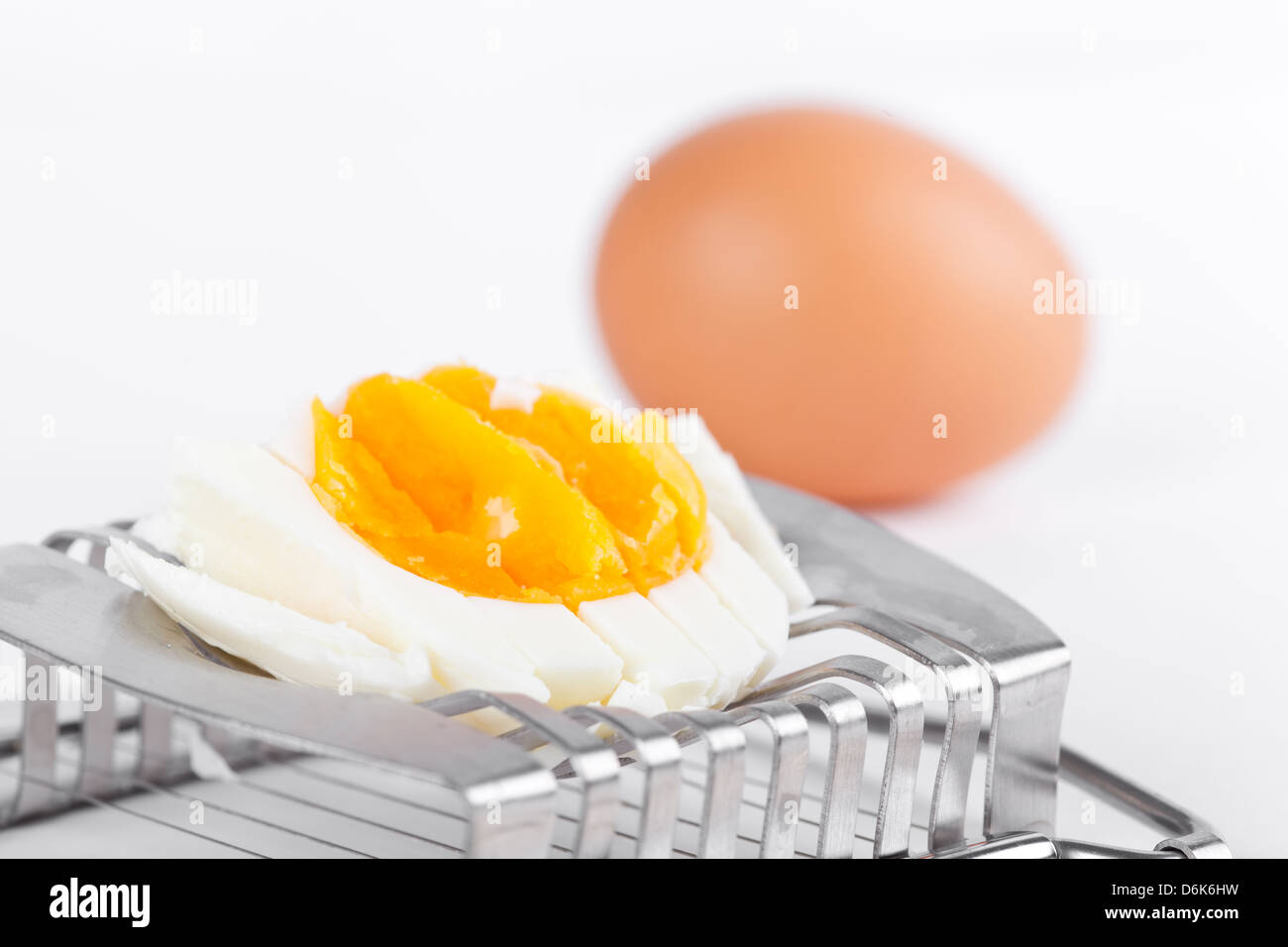 Cutted egg on cutter, closeup on white Stock Photo - Alamy