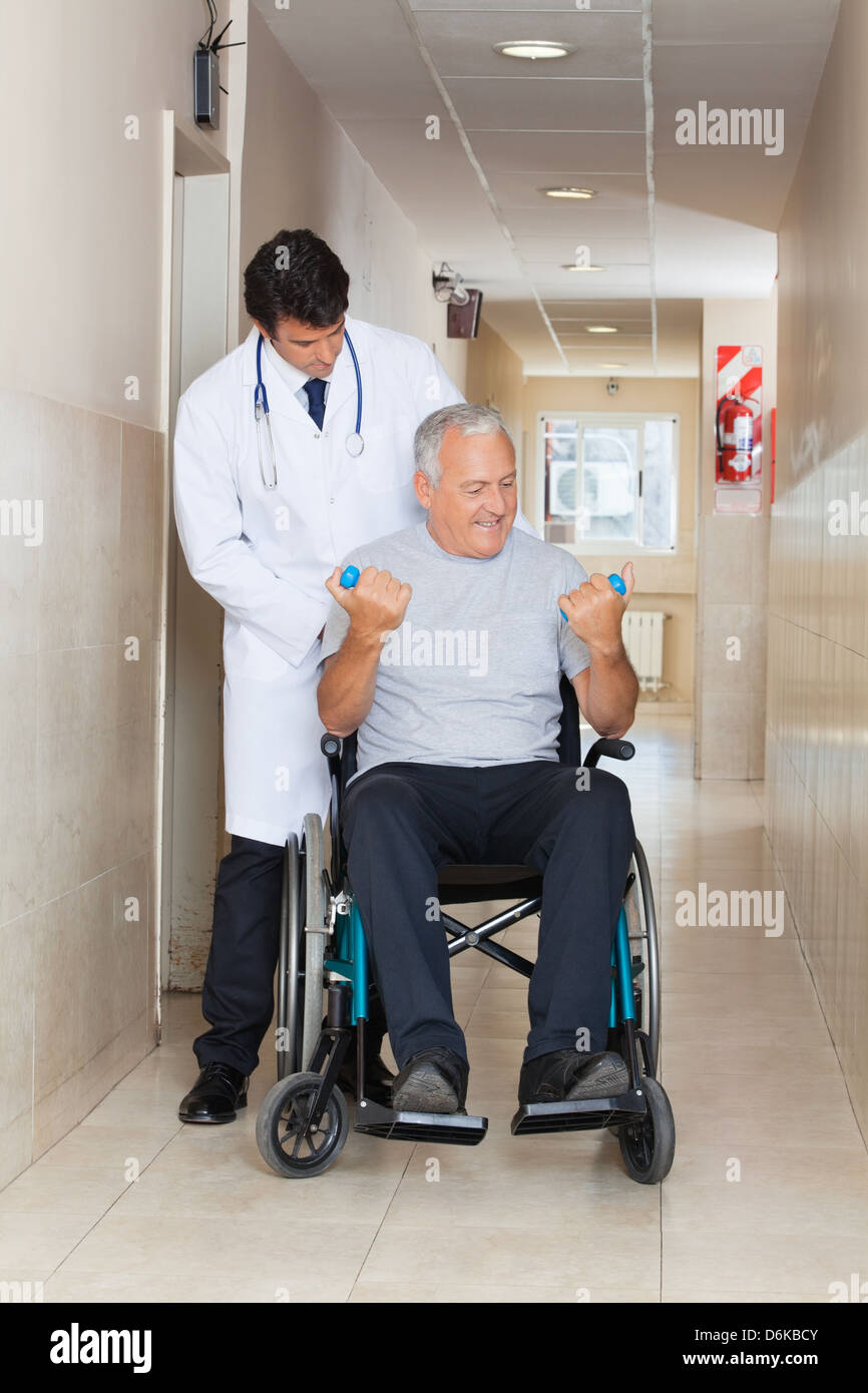 Doctor Giving Muscle Training To The Senior Man Stock Photo - Alamy