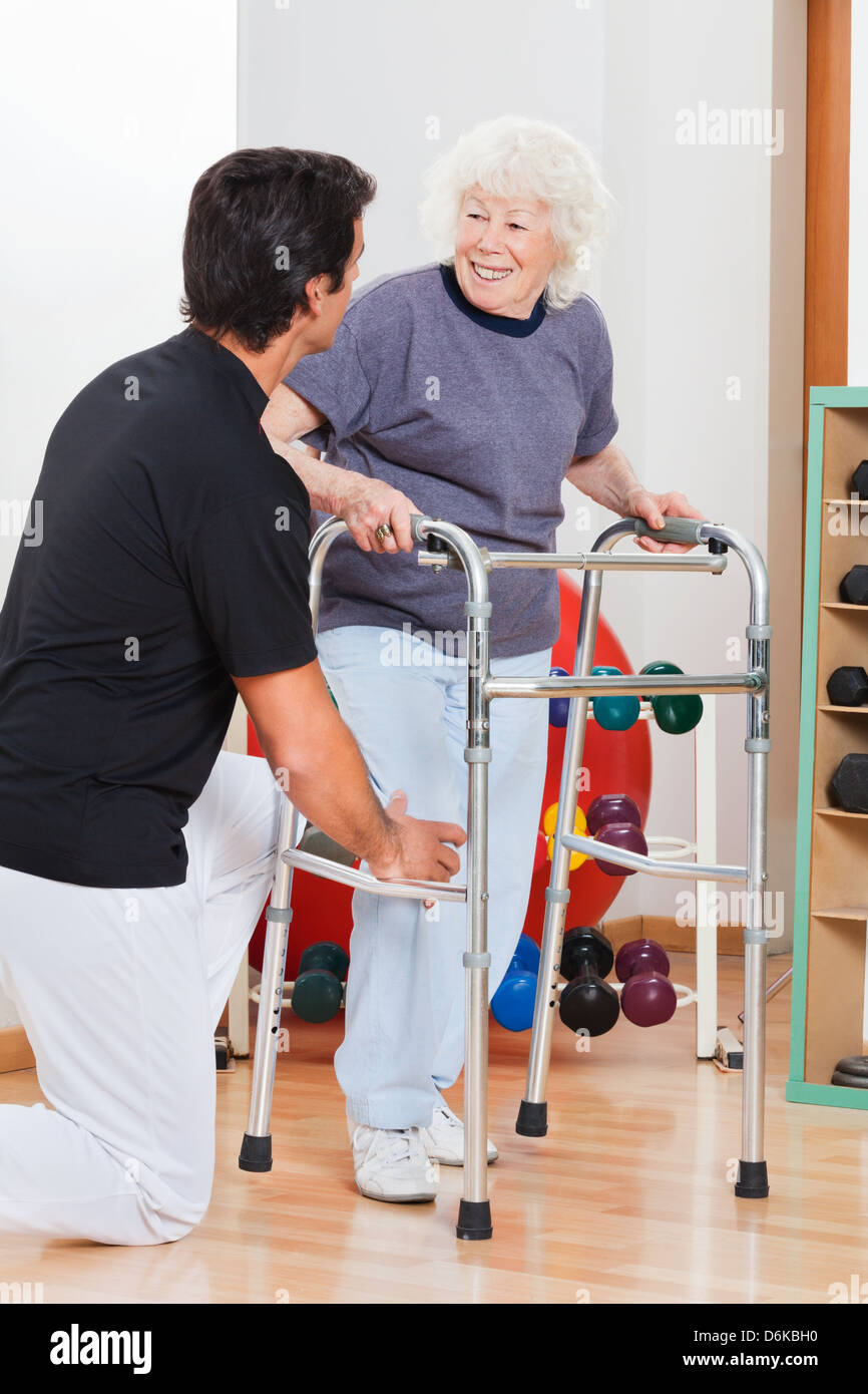 Woman With Walker Looking At Trainer Stock Photo - Alamy