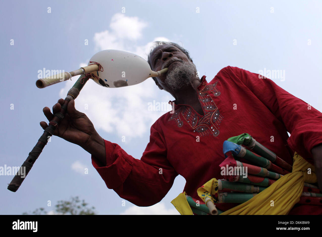 Bangladesh. 19th April, 2013. A Bangladeshi flute singer singing his ...