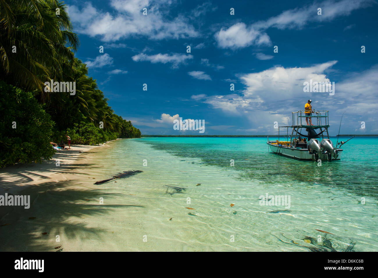 Little motor boat in the turquoise waters of the Ant Atoll, Pohnpei ...