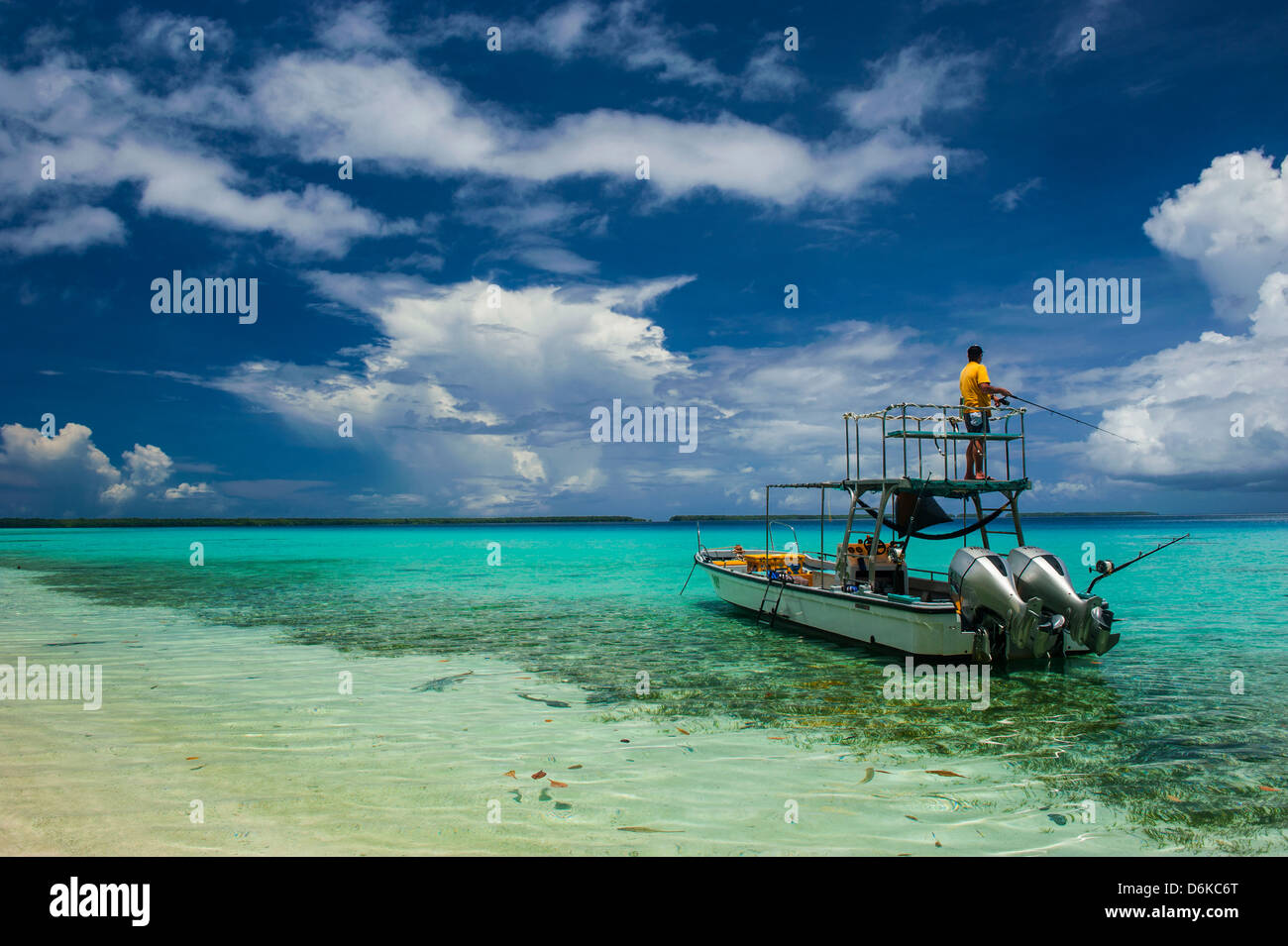 Little motor boat in the turquoise waters of the Ant Atoll, Pohnpei ...