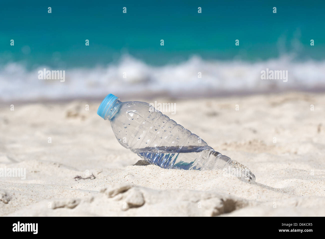 Drinking water in bottle on sand on beach Stock Photo - Alamy