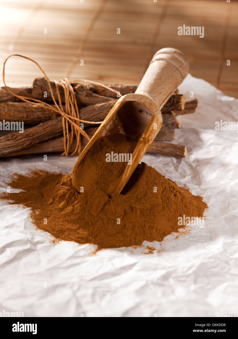 Heap of ground licorice and bundled liquorice roots Stock Photo - Alamy