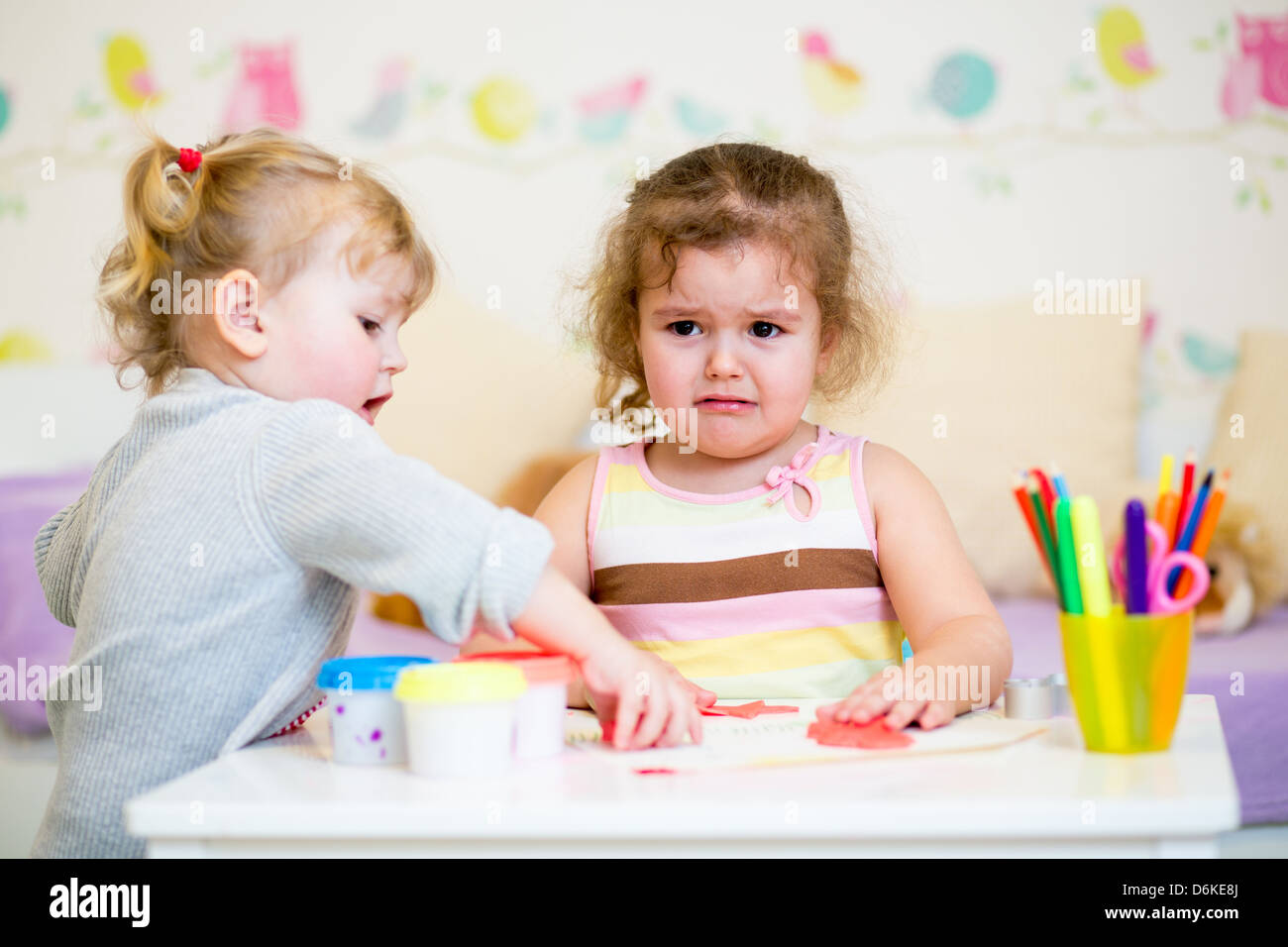 kid offended by her younger sister Stock Photo - Alamy
