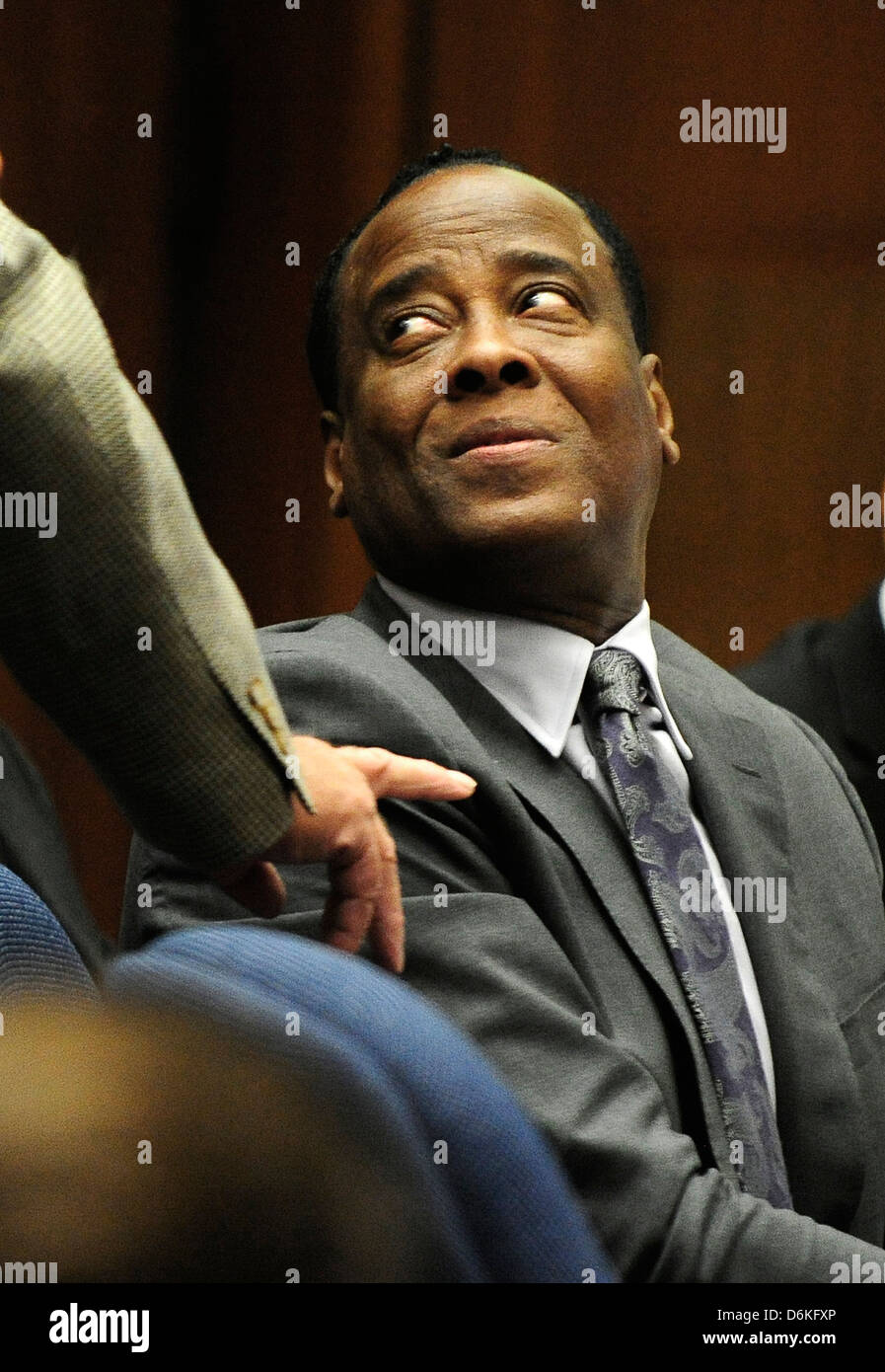 Dr. Conrad Murray looks up at a former patient of his that testified as ...