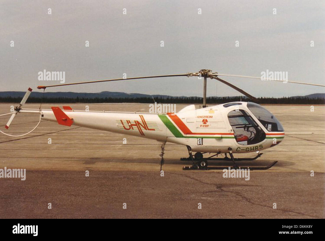 This image features an Enstrom F28C helicopter, known for its use in ...