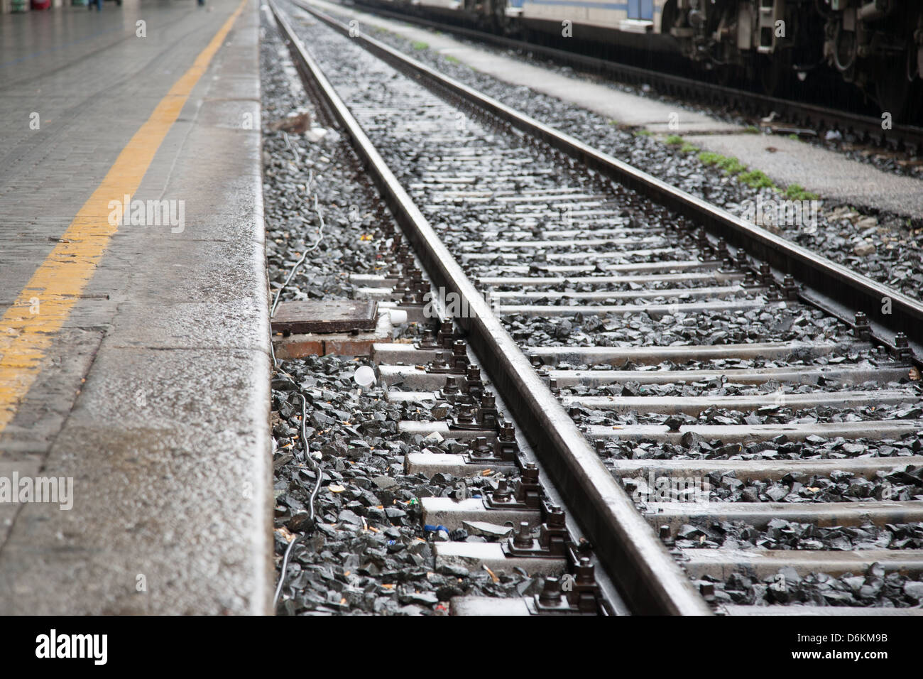 Railroad Platform with Train and Track with Yellow Line Stock Photo - Alamy