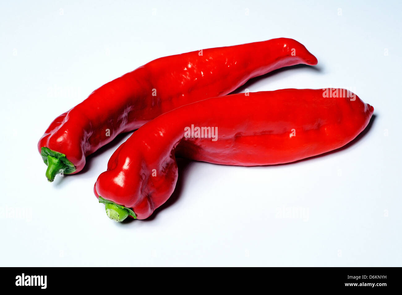 Two red Italian pointed peppers against a white background Stock Photo ...