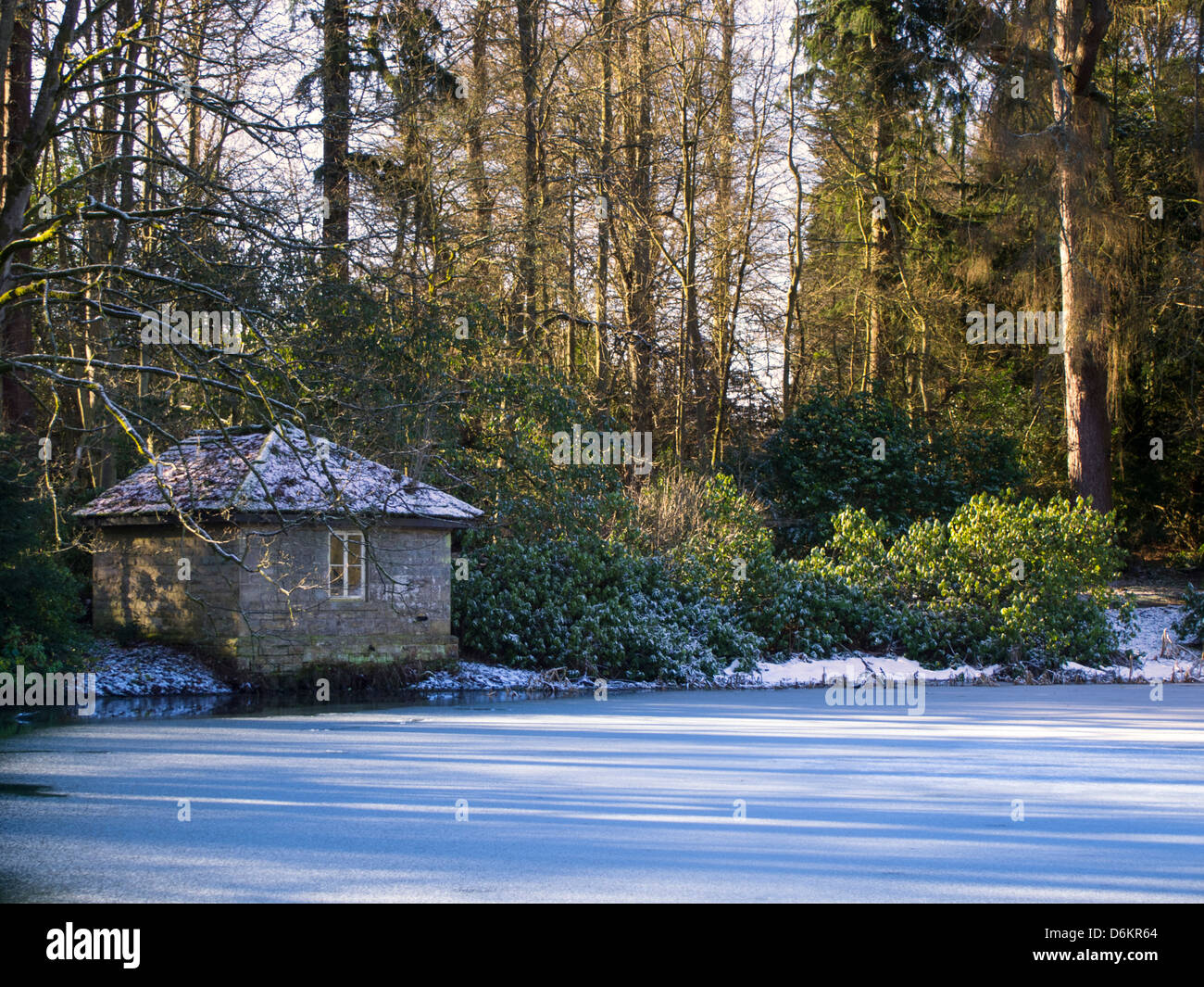 Stone builiding alongside an ice-covered lake in the Wallington Hall ...