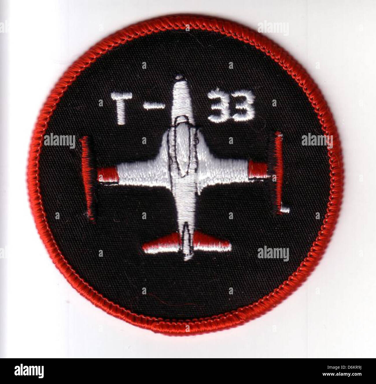 A photograph of a T-33 badge, likely related to the T-33 aircraft. The ...