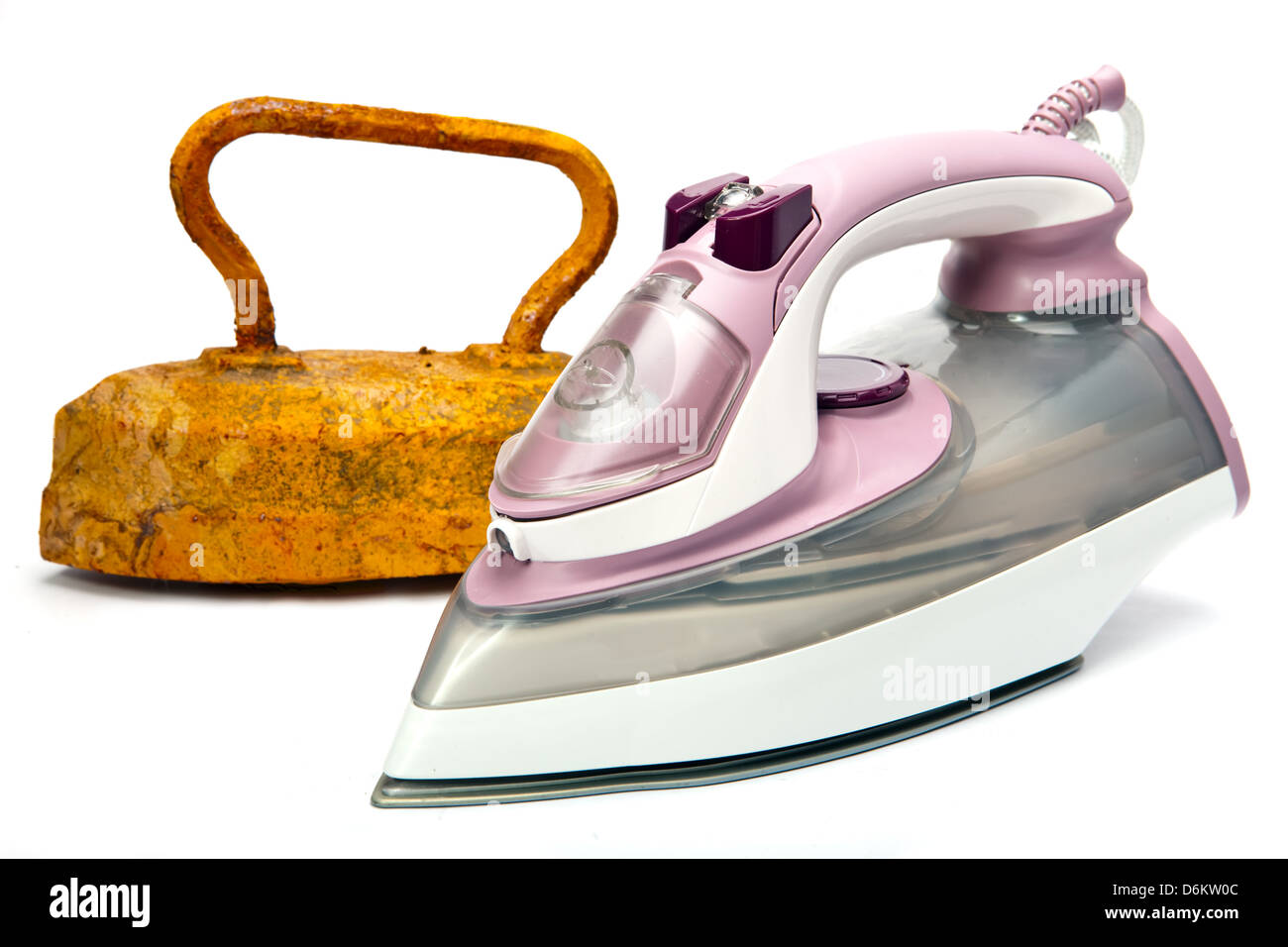 Old rusty pig-iron iron and modern new electric iron on white ...