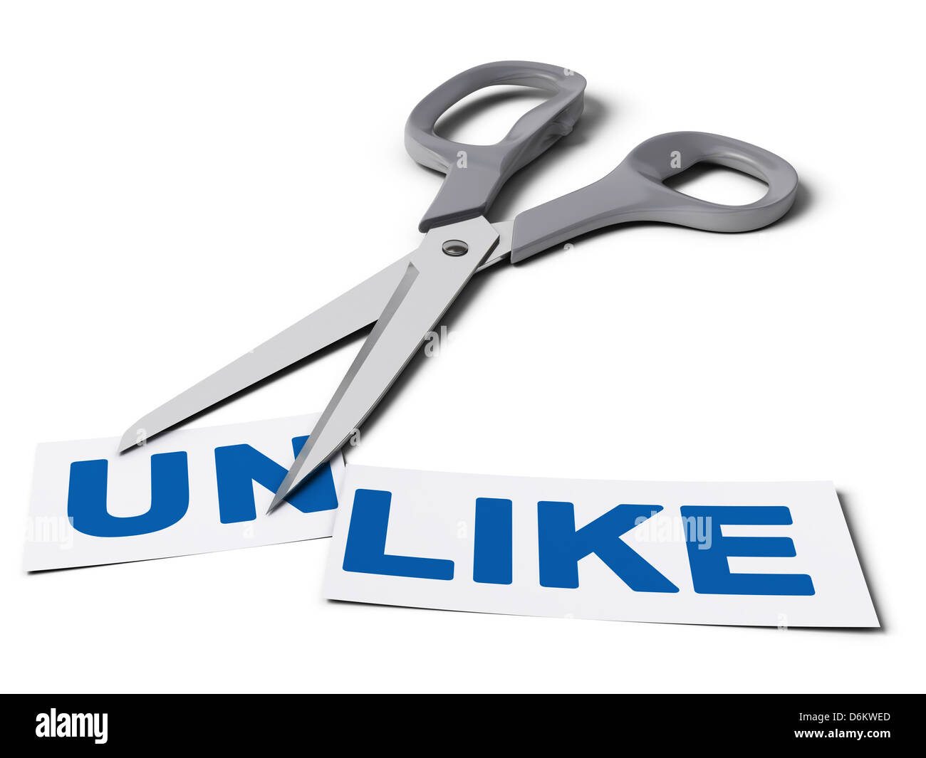 Scissors cut the word unlike in two parts, the first one with the ...