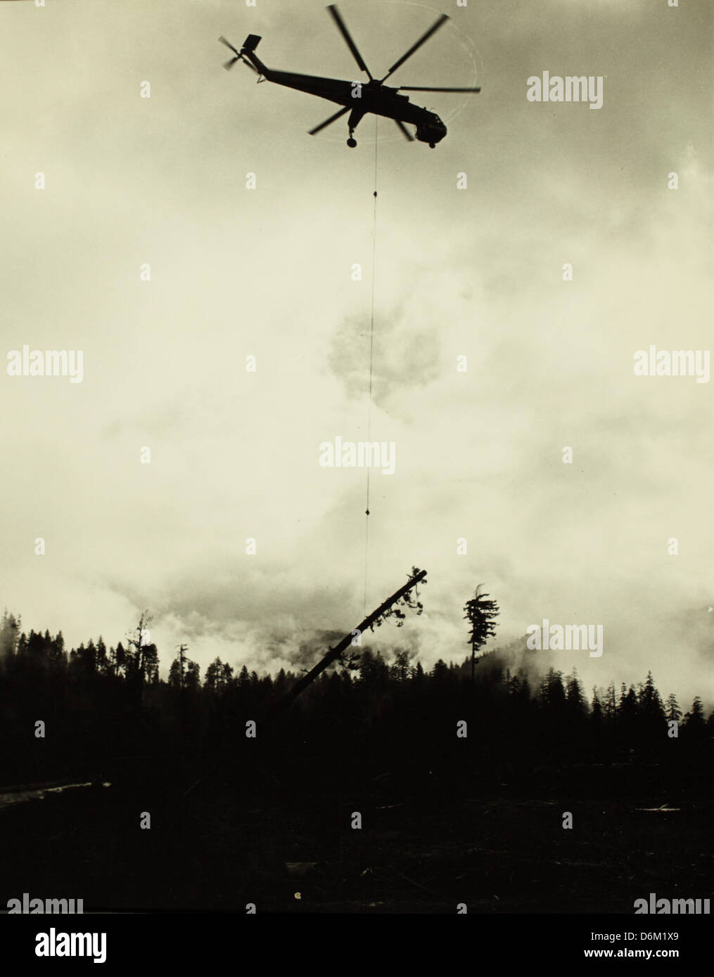 This image shows a Skycrane helicopter performing an operation to lift ...