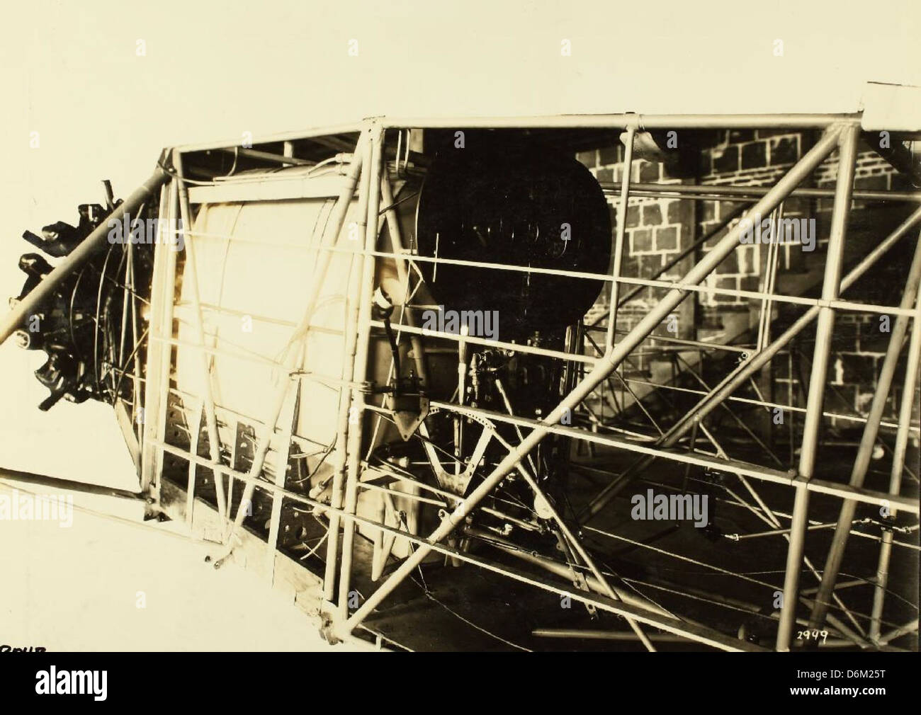 An uncovered aircraft fuselage frame reveals the structural components ...