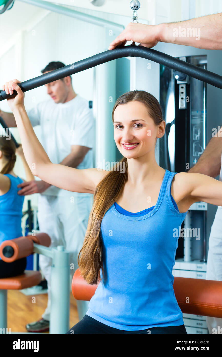 Patient at the physiotherapy making physical exercises with her ...