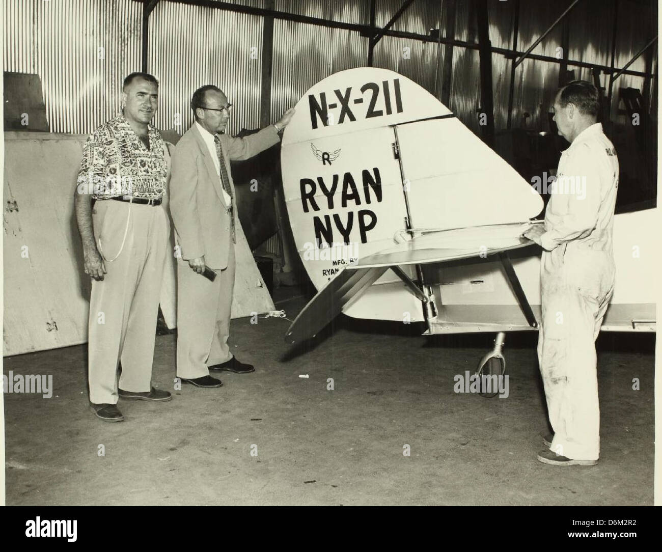 Pilot Paul Mantz and director Billy Wilder examine the replica of the ...