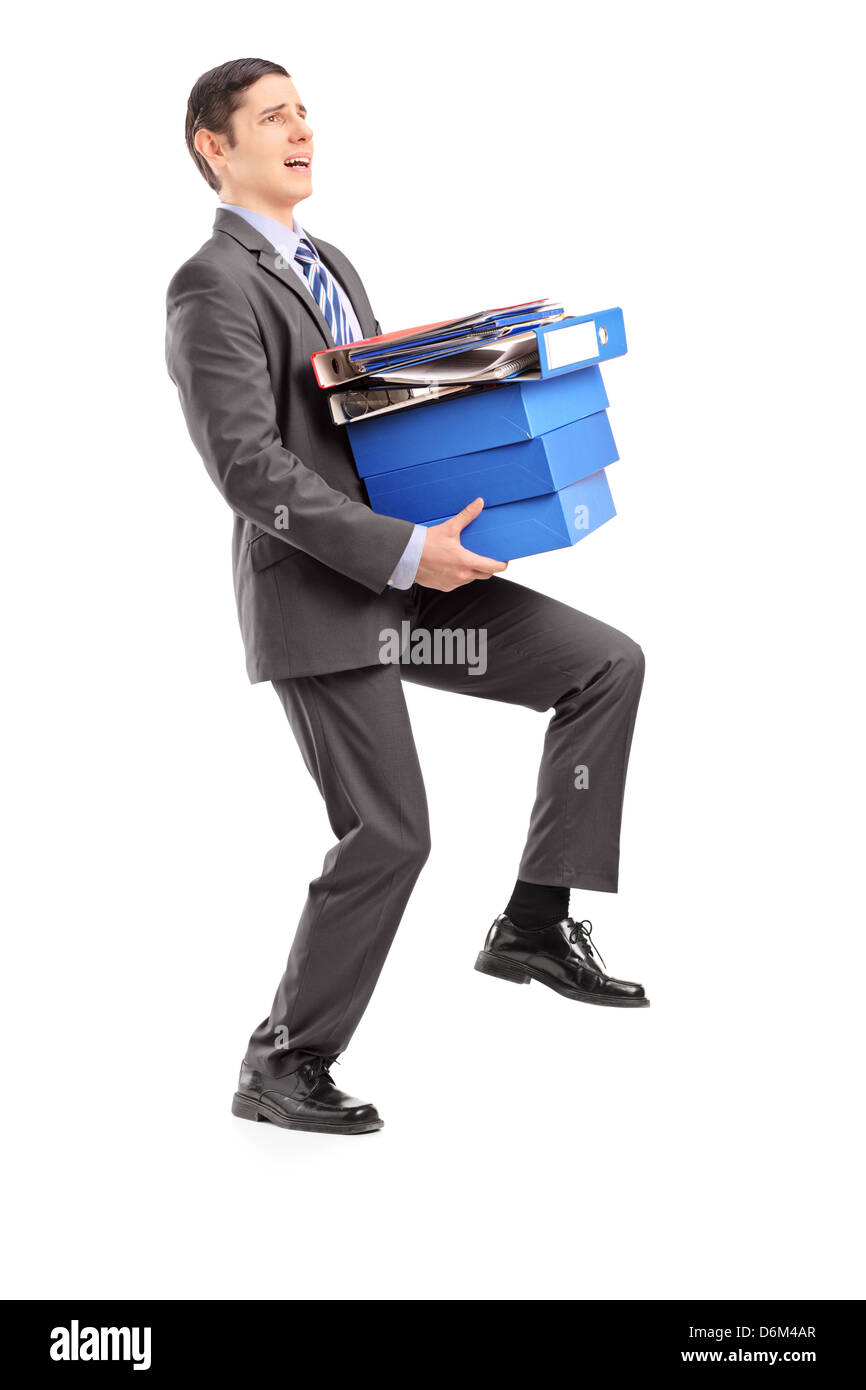 Full length portrait of a professional man carrying heavy folders ...